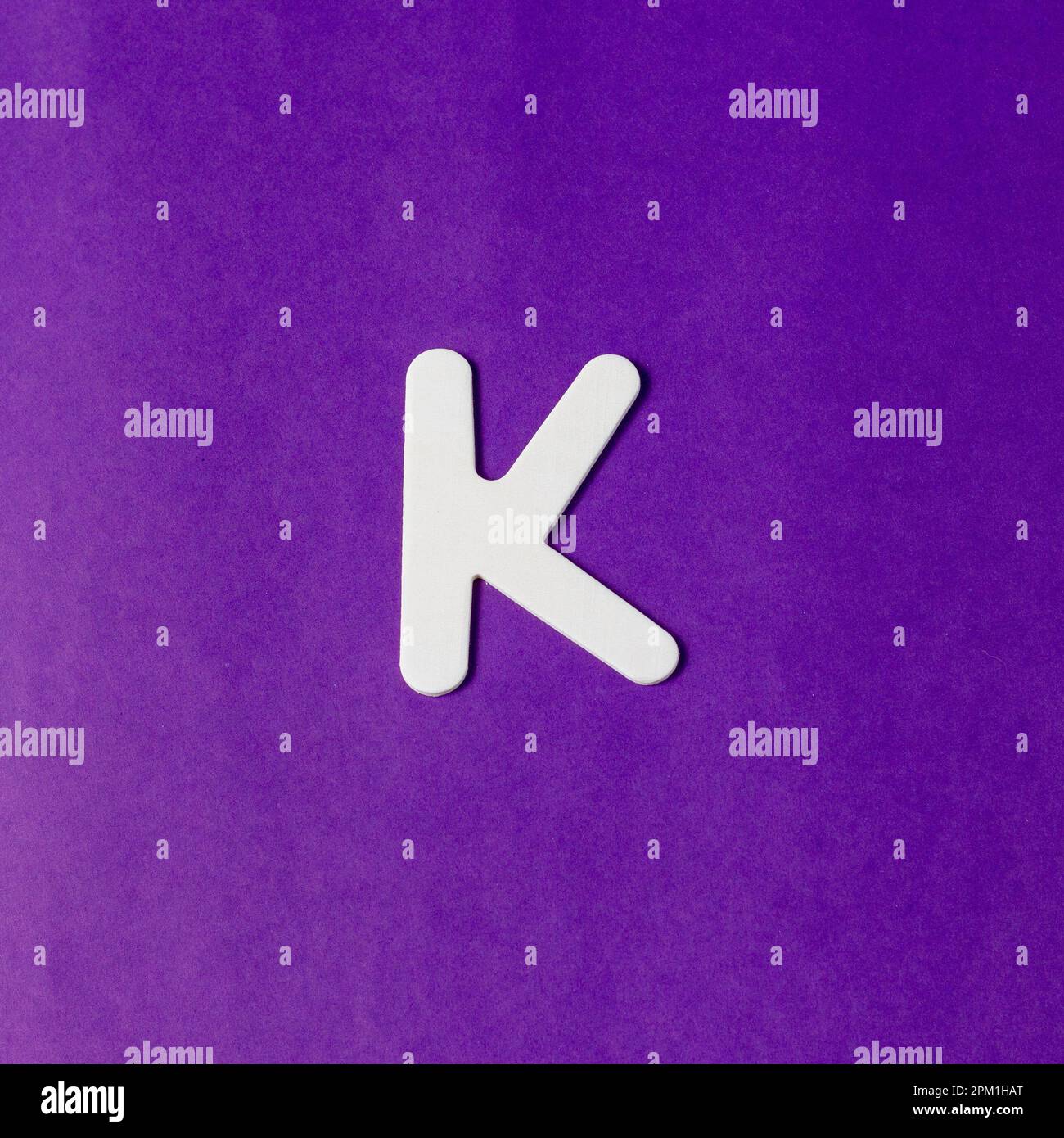 Letter K in wood texture - Purple background Stock Photo - Alamy