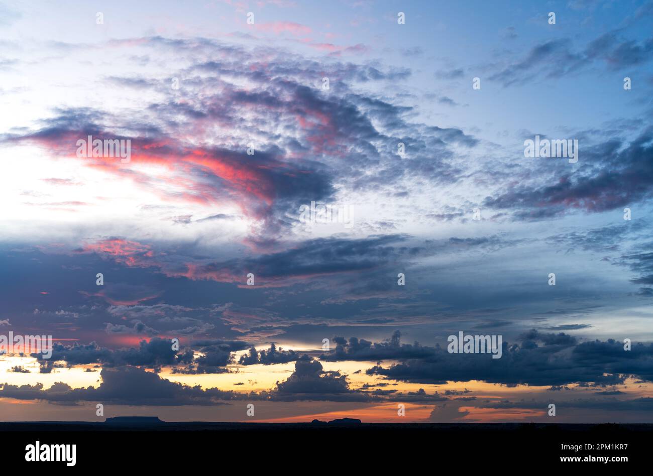 Mesmerizing sunset sky with black plateaus on the horizon Stock Photo ...