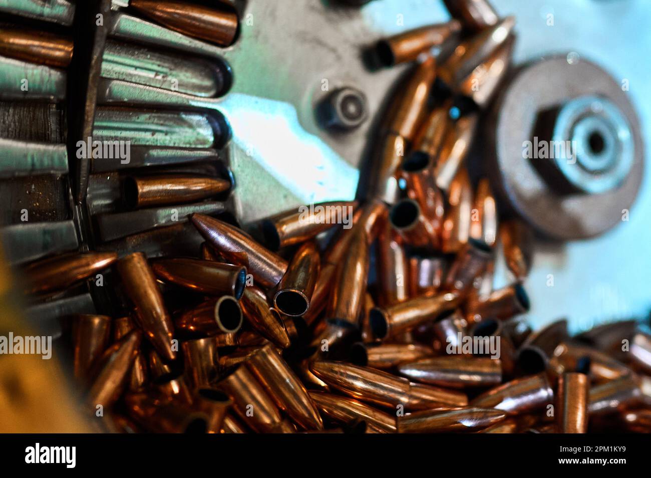 Pile of Copper bullet shells and turning wheel at production line Stock ...