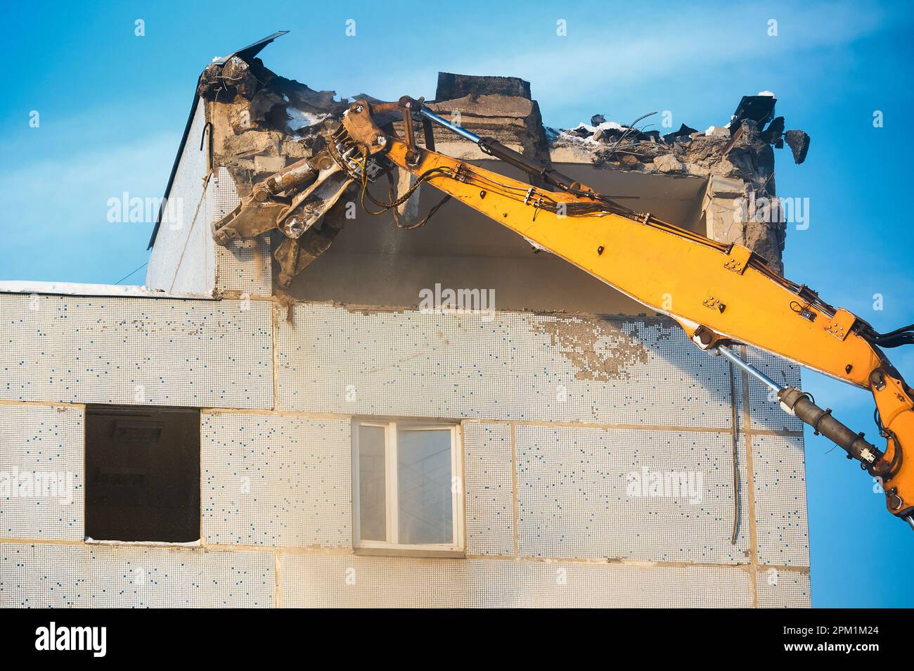 Building dismantling with high-altitude excavator destroyer Stock Photo ...