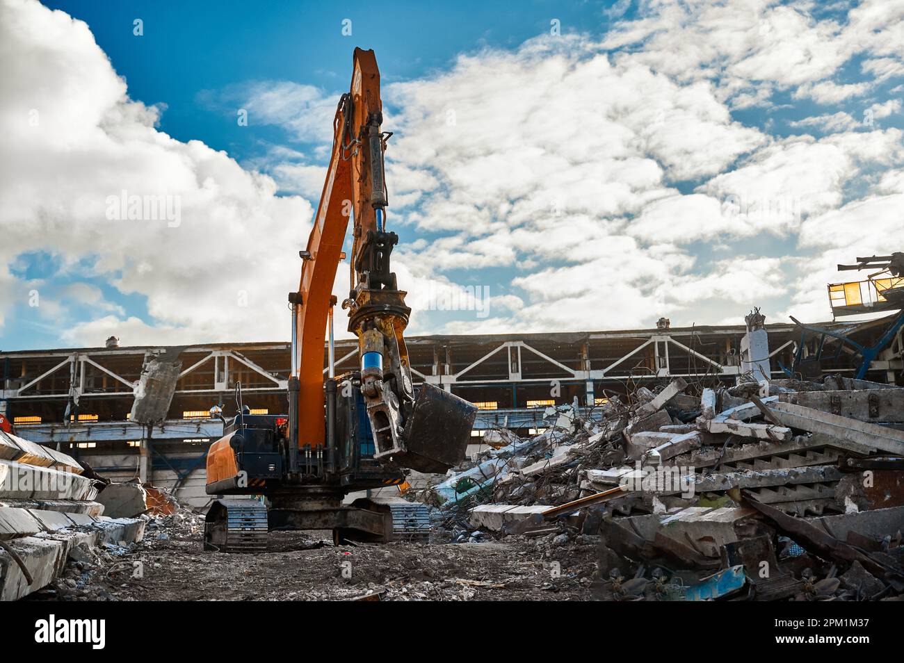 Excavator destroyer removes debris winter day Stock Photo - Alamy