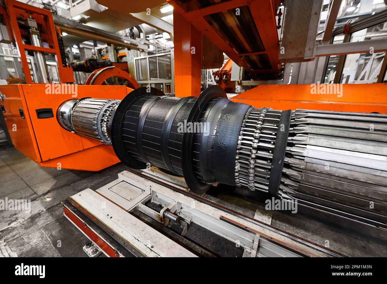 Metal shaft with rubber layers and equipment to form tire Stock Photo ...