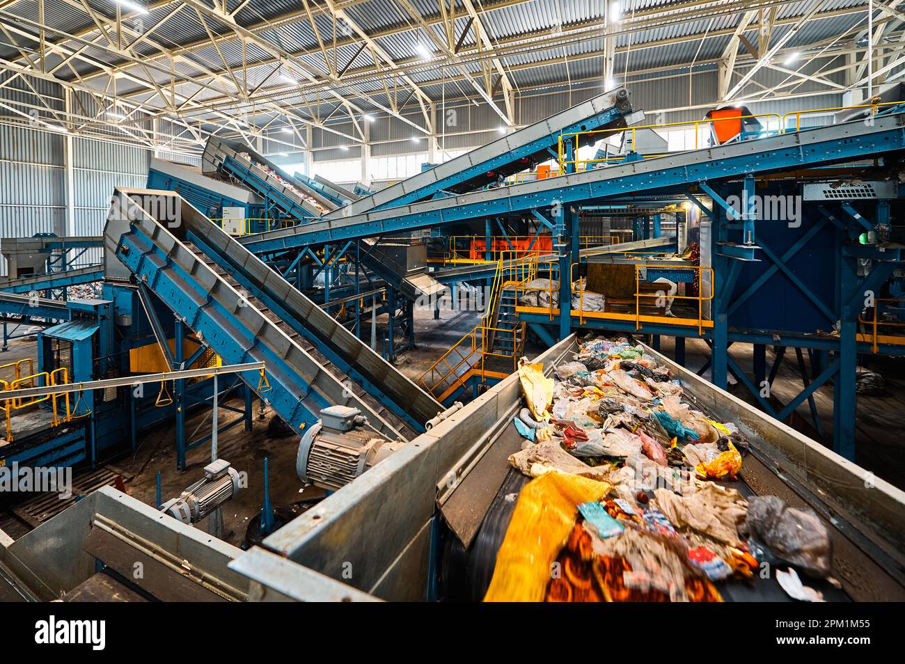 Conveyor carries trash pieces in recycling plant workshop Stock Photo ...