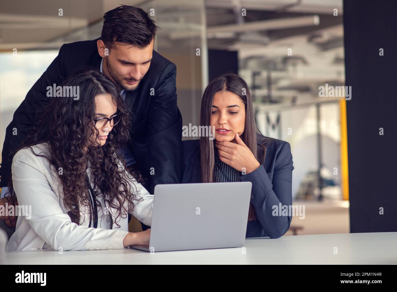 Focused startup team using laptops hi-res stock photography and images ...