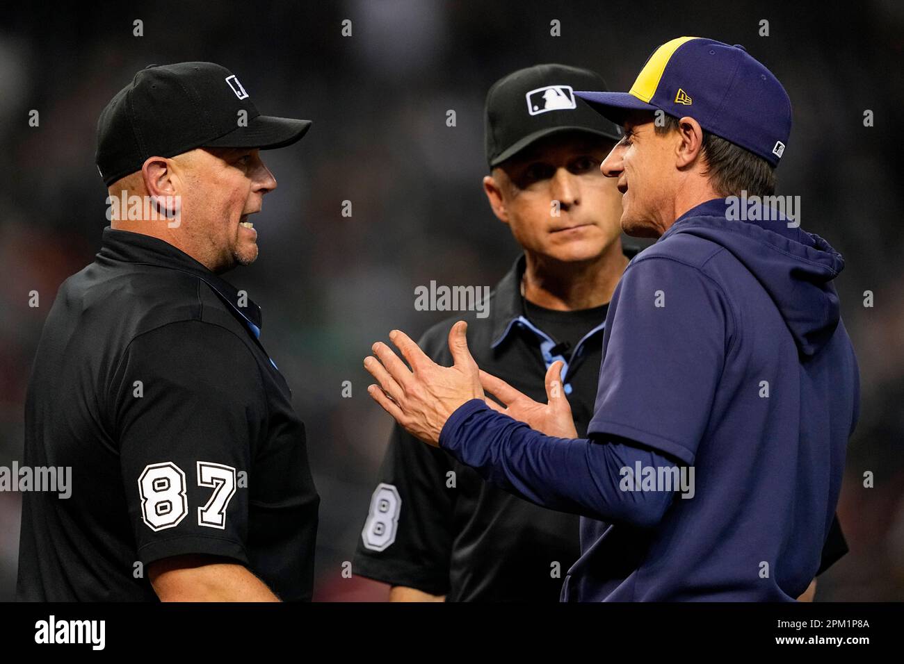 Milwaukee Brewers manager Craig Counsell, right, argues with home plate umpire Scot Barry, left ...