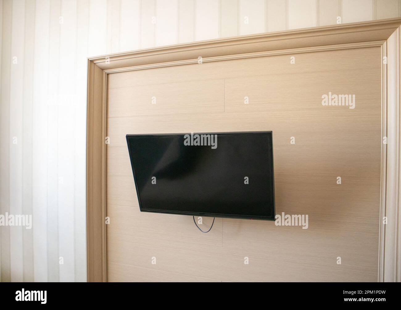 Modern design of a room with a black plasma LED TV on the wall, a mock ...