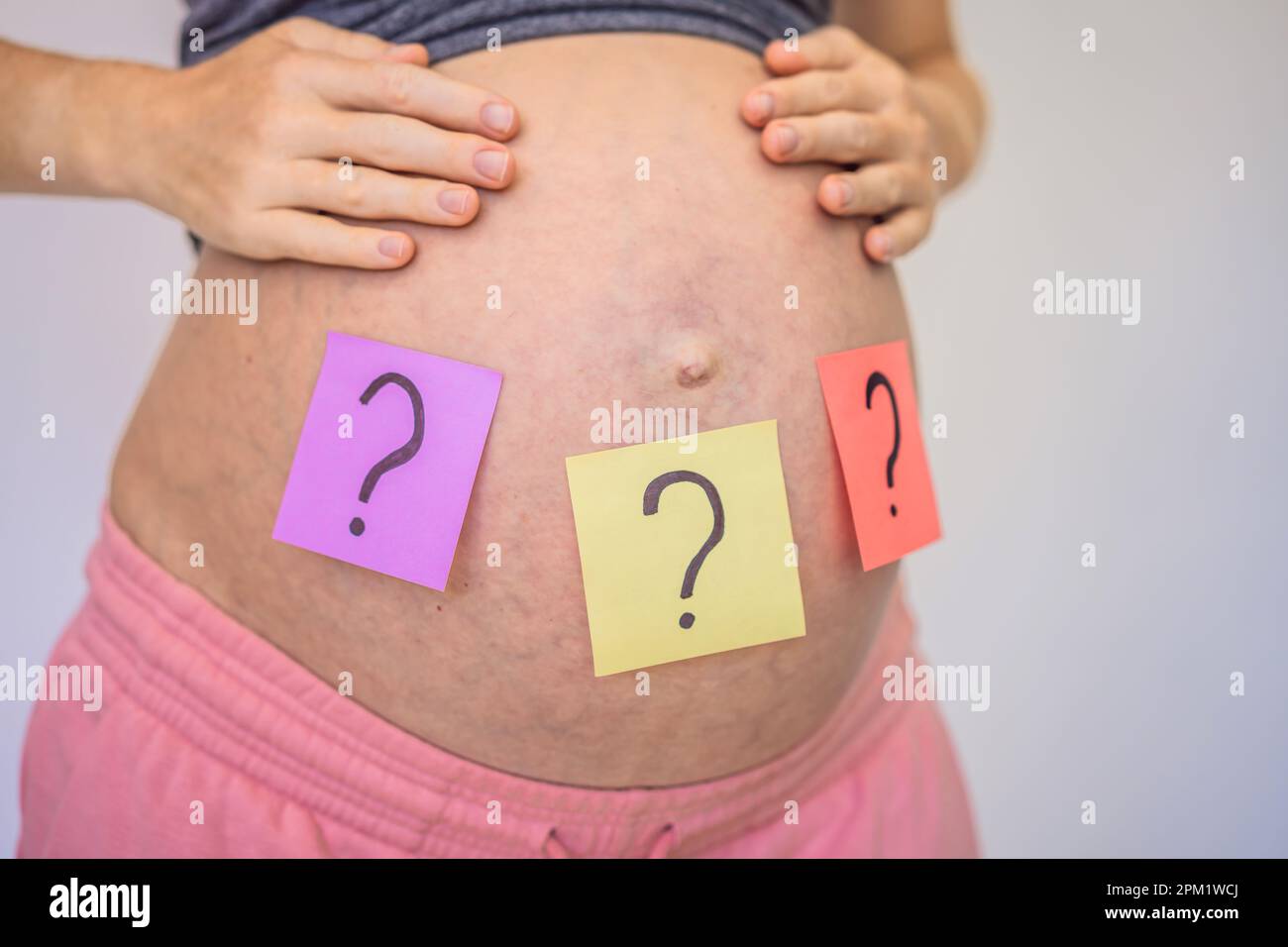 Choosing baby name. Confused pregnant woman with question marks on ...