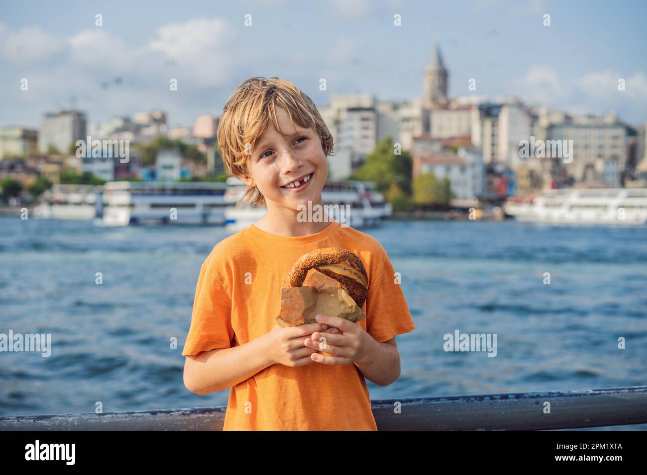 Boy in Istanbul having breakfast with Simit and a glass of Turkish tea ...