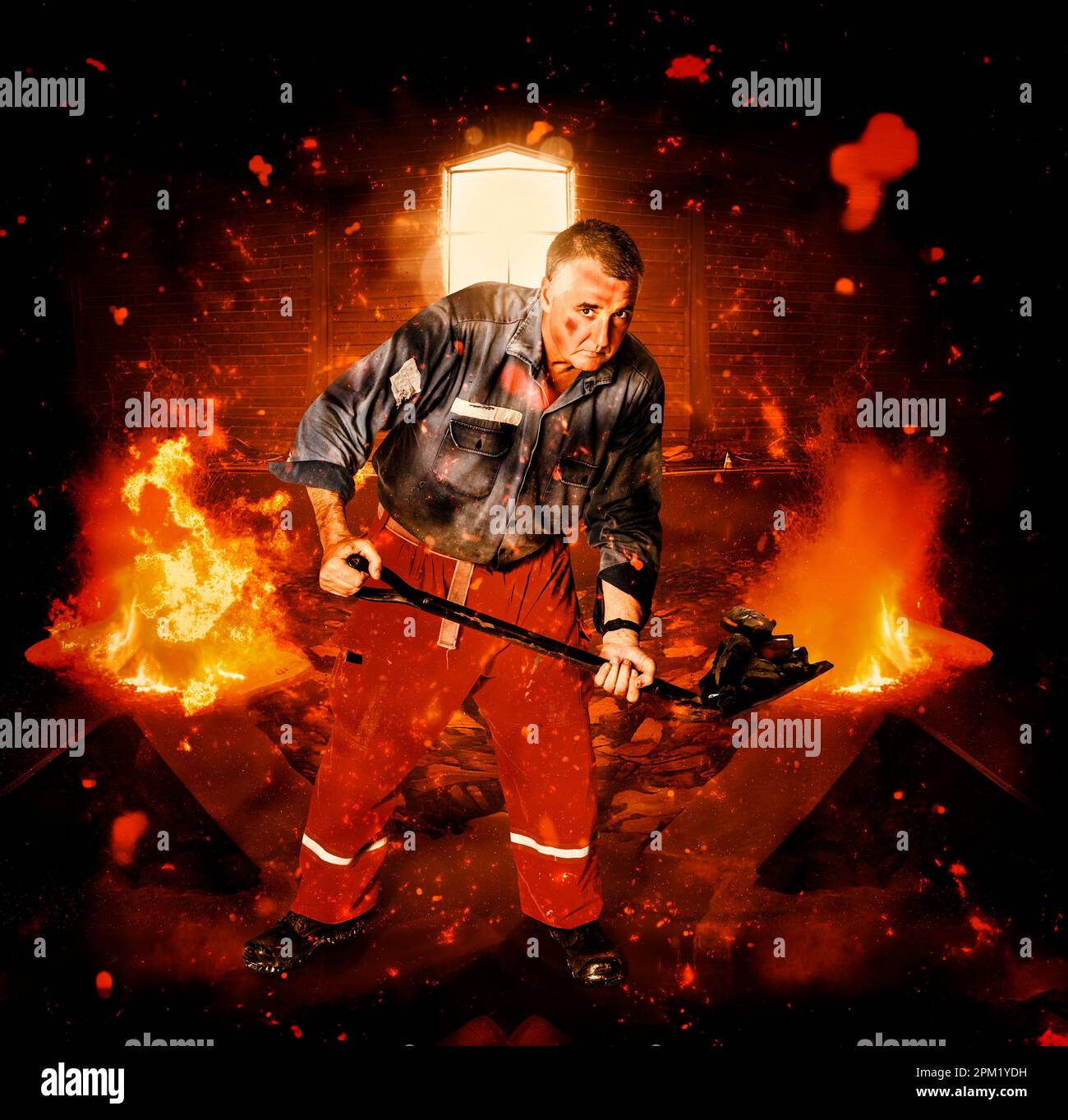 Stoking the system a worker feeds coal into a fire furnace in boiler ...