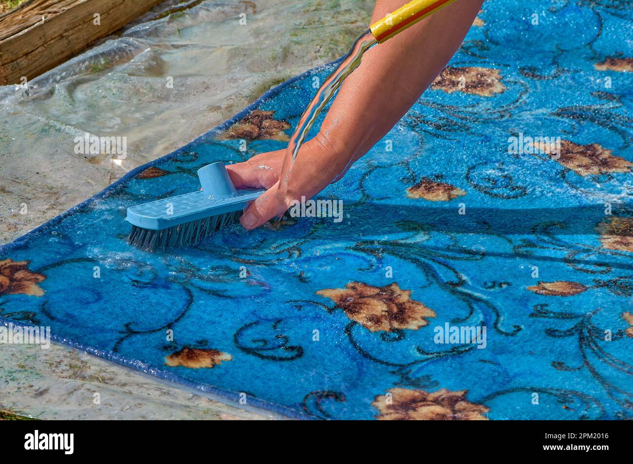 soaping the carpet, washing the carpet on the street Stock Photo - Alamy