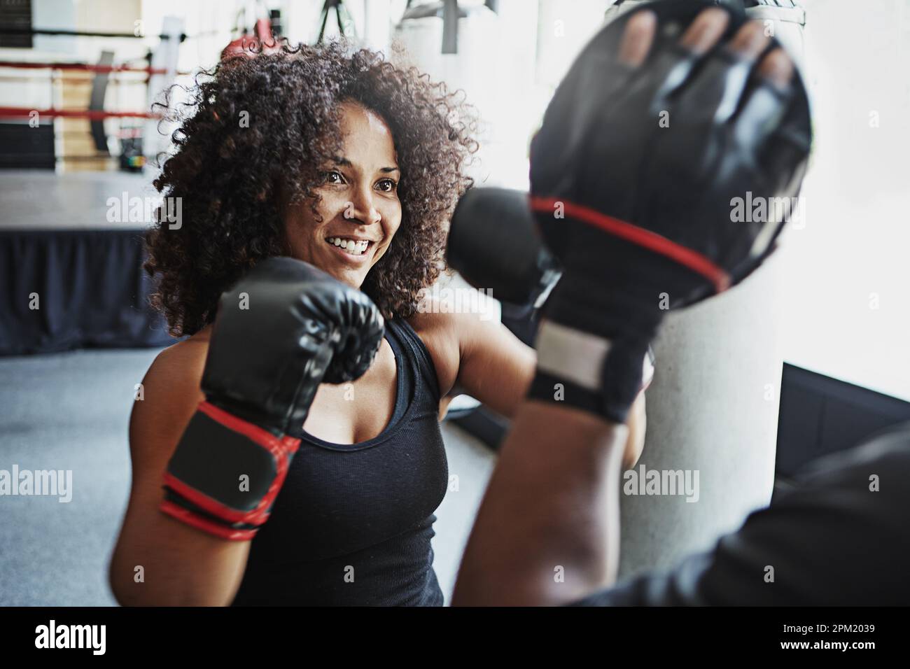The best fighter is never angry. a female boxer practising her moves ...