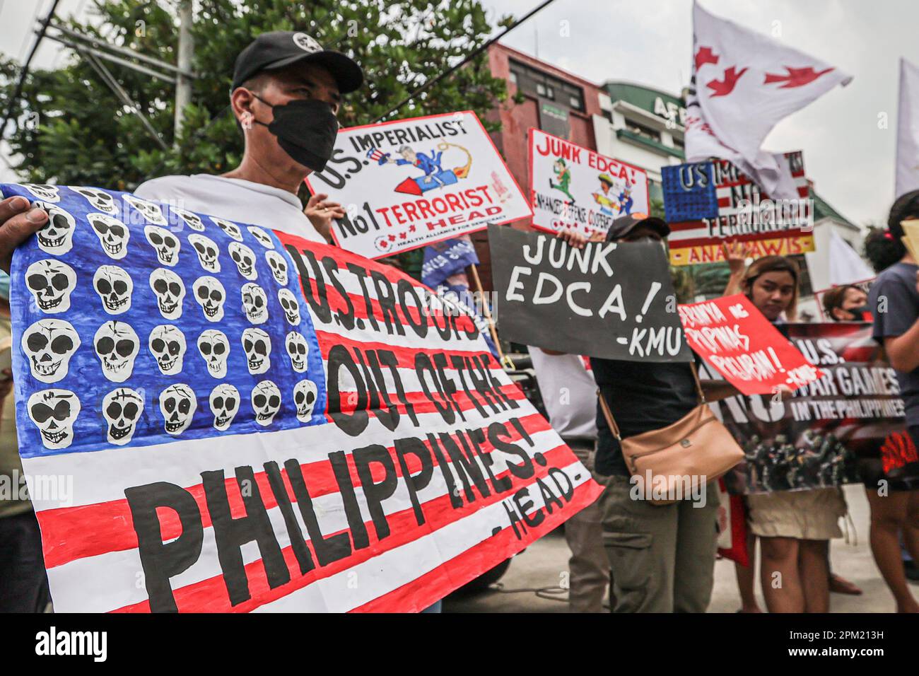 Demonstrators carry placards and shout slogans during a rally in front ...