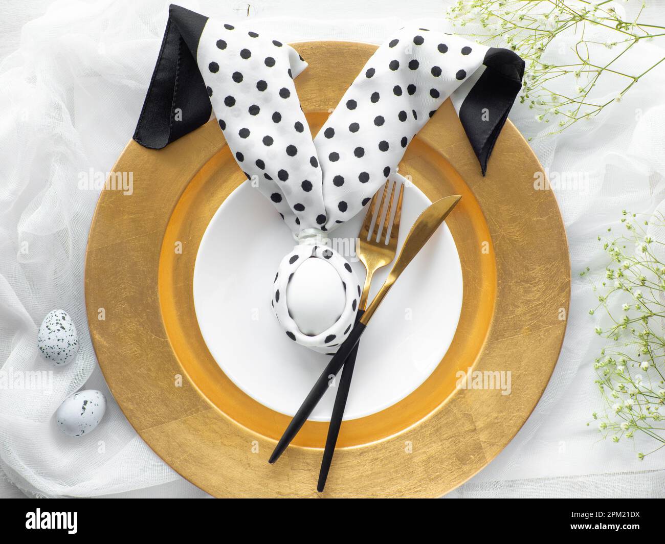 Festive Easter table setting with eggs and flowers on white background ...