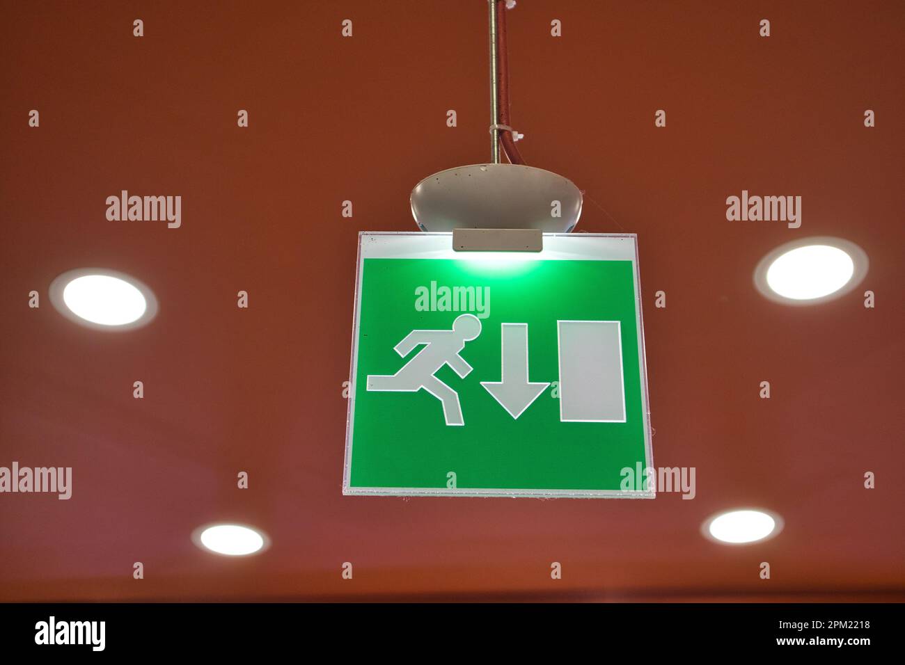 Green emergency exit sign indoors Stock Photo - Alamy