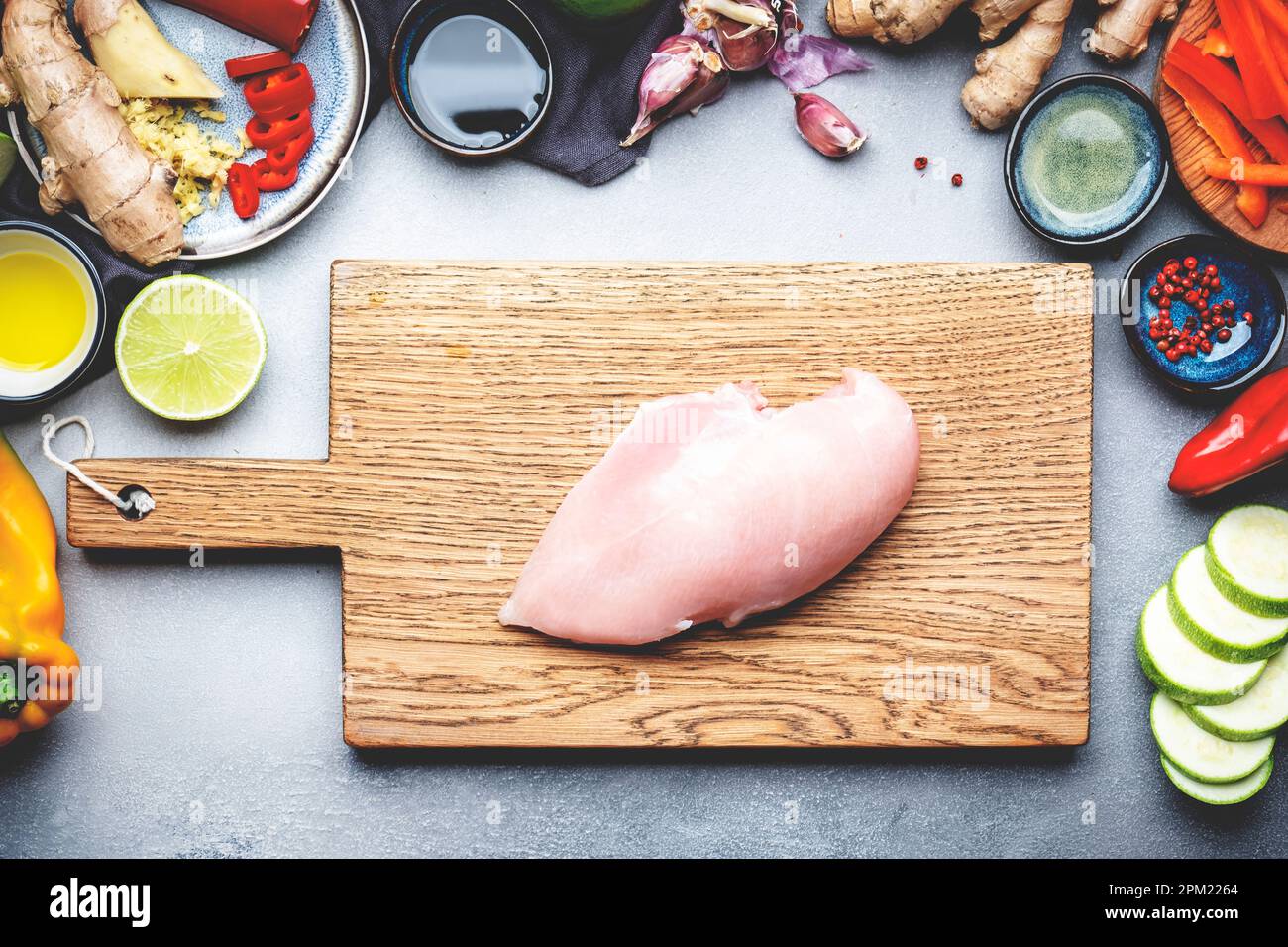 Food background. Raw chicken fillet on cutting board., vegetables ...
