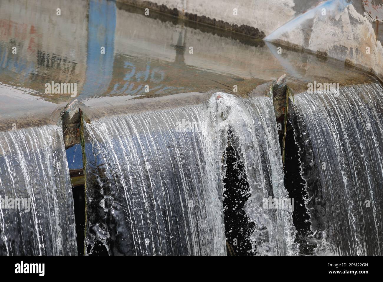 Water flowing through a sluice on a concrete man made river Stock Photo ...