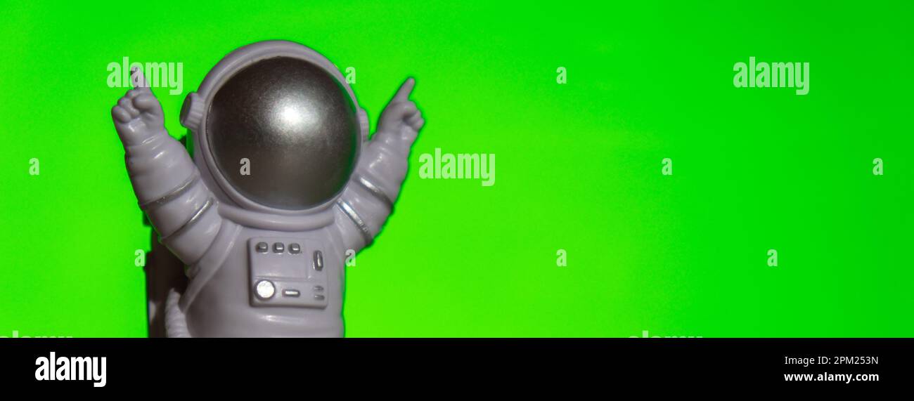 Plastic toy astronaut on green chroma key background Template Mock up ...