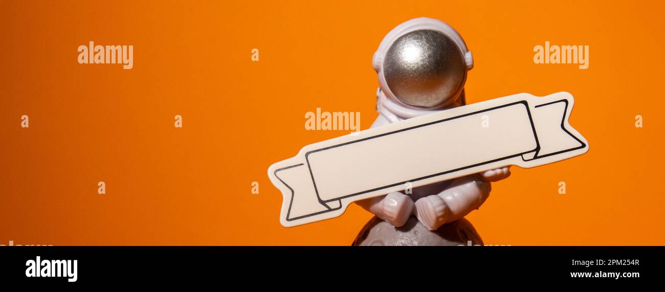 Plastic toy astronaut with paper note template mock up for your text on ...
