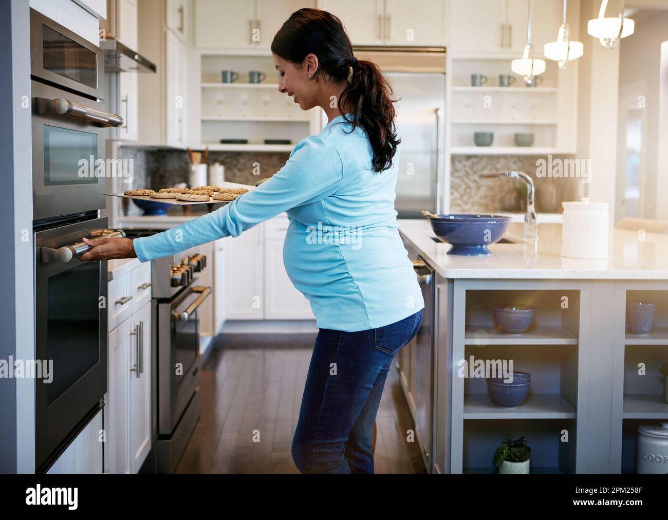 These look absolutely delicious. a pregnant woman taking a tray of ...