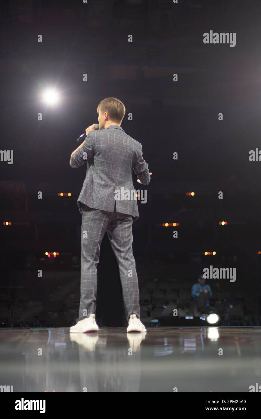 artist performs on stage with a microphone in his hand Stock Photo - Alamy