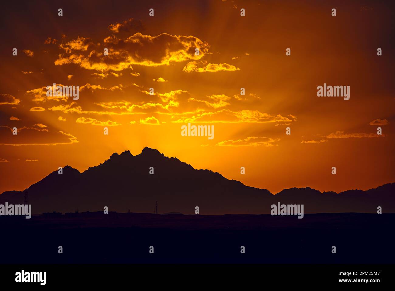 Beautiful sunset over a majestic mountain landscape in the far distance ...