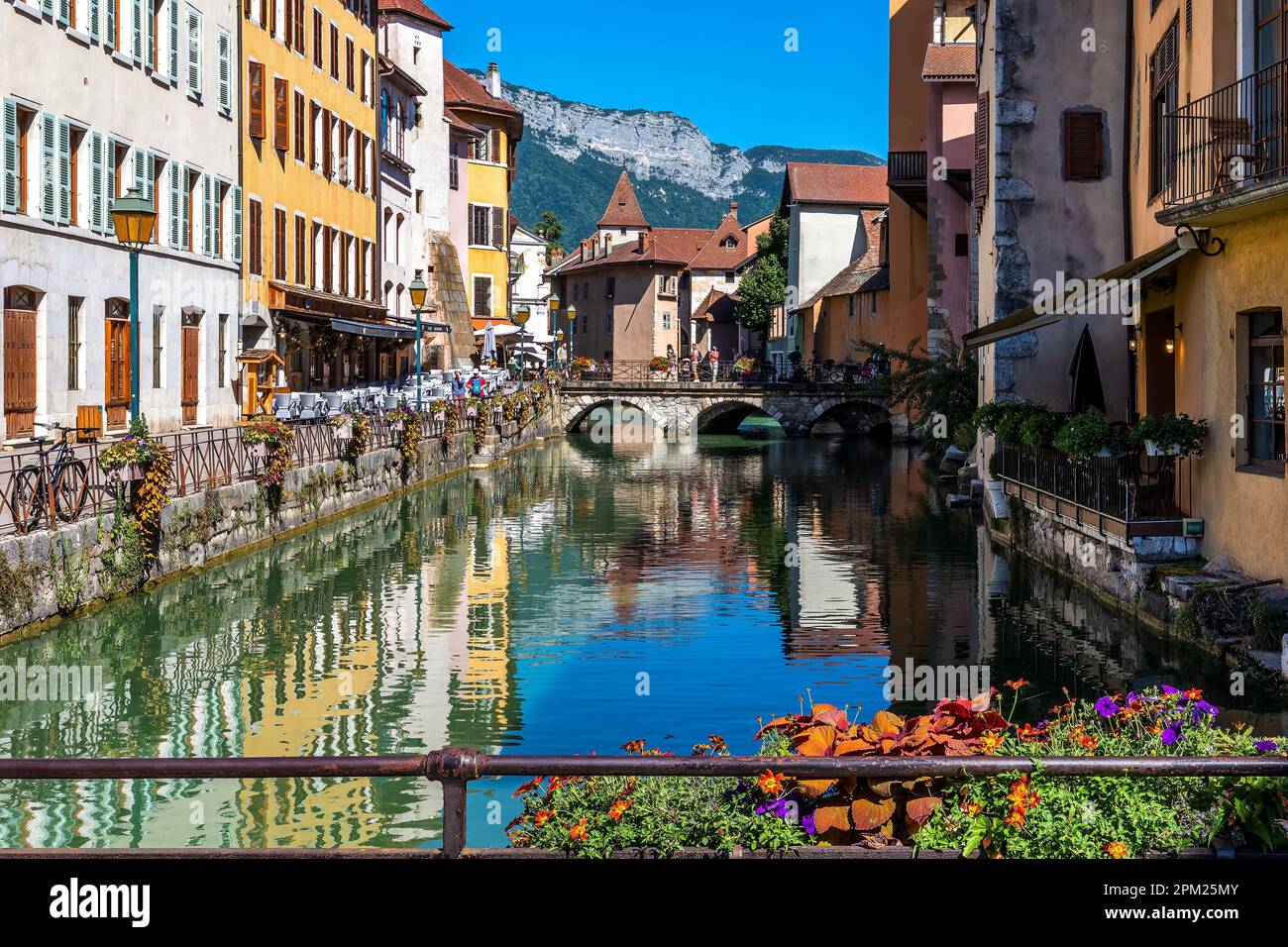 View of narrow canal among medieval houses in old town of Annecy ...