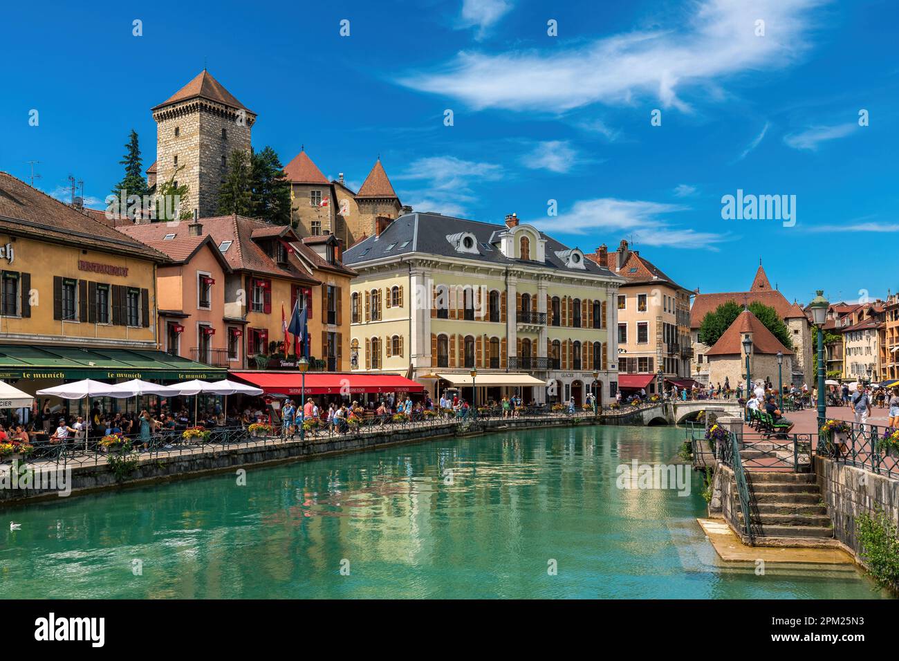 View of canal along promenade with outdoor restaurants and colorful ...