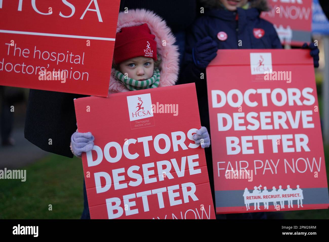 A child joins striking NHS junior doctors on the picket line outside ...