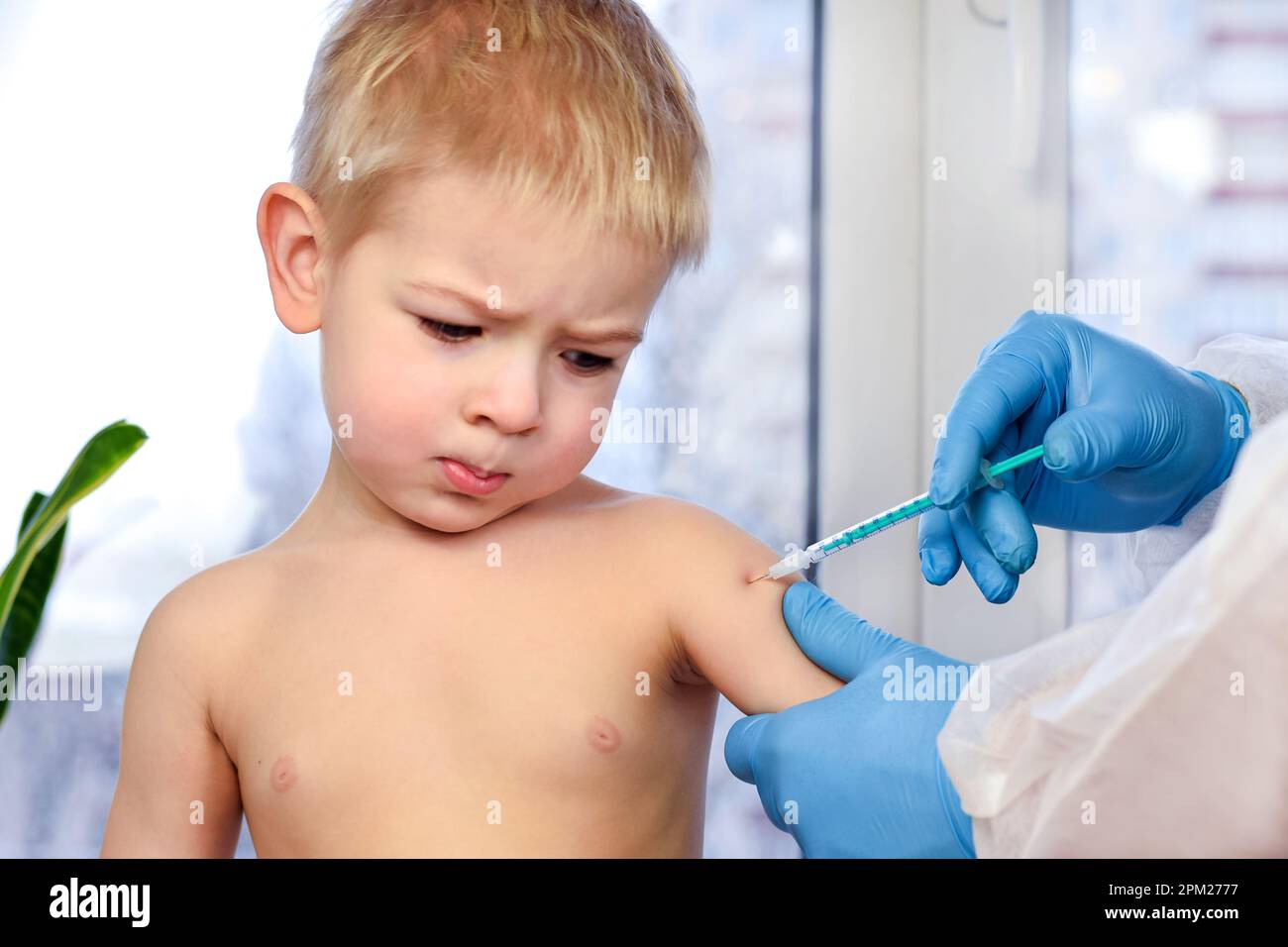 Doctor injecting vaccination in arm of a little boy. Coronavirus ...