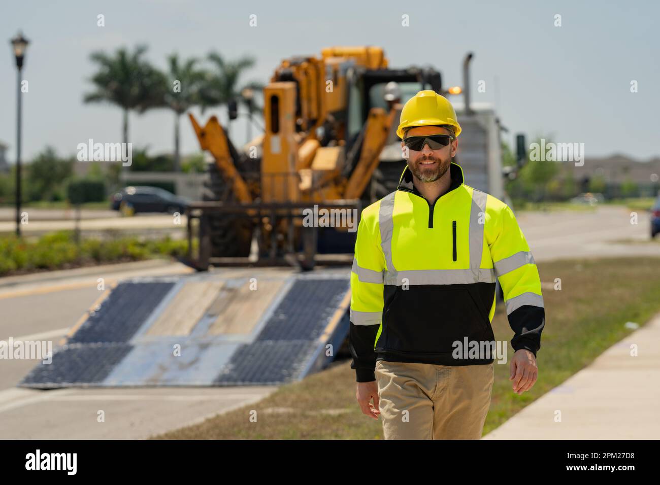Portrait of builder in a construction site. Builder with excavator ...