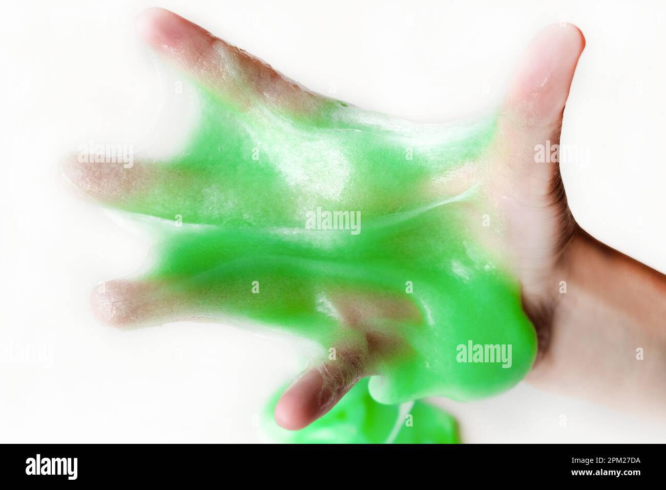 Hand Playing with textured slime with bubbles, stretching the gooey ...