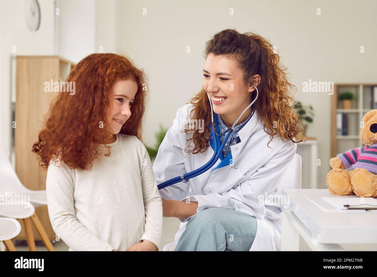 Happy cute little child getting a medical lung checkup at the ...