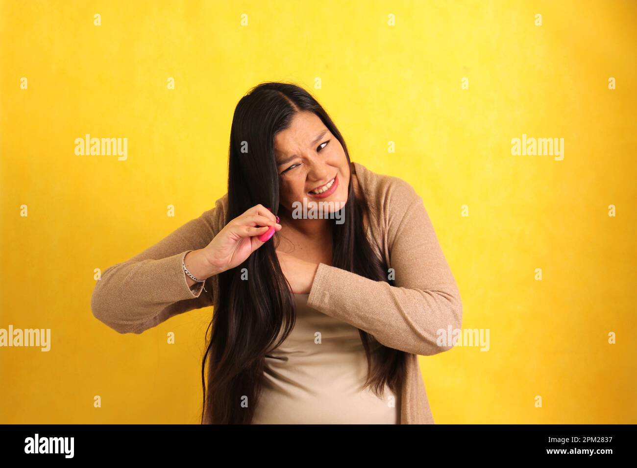 Latin Adult Woman With Very Long Straight Hair Troublesomely Brushes Her Hair With Hairbrush