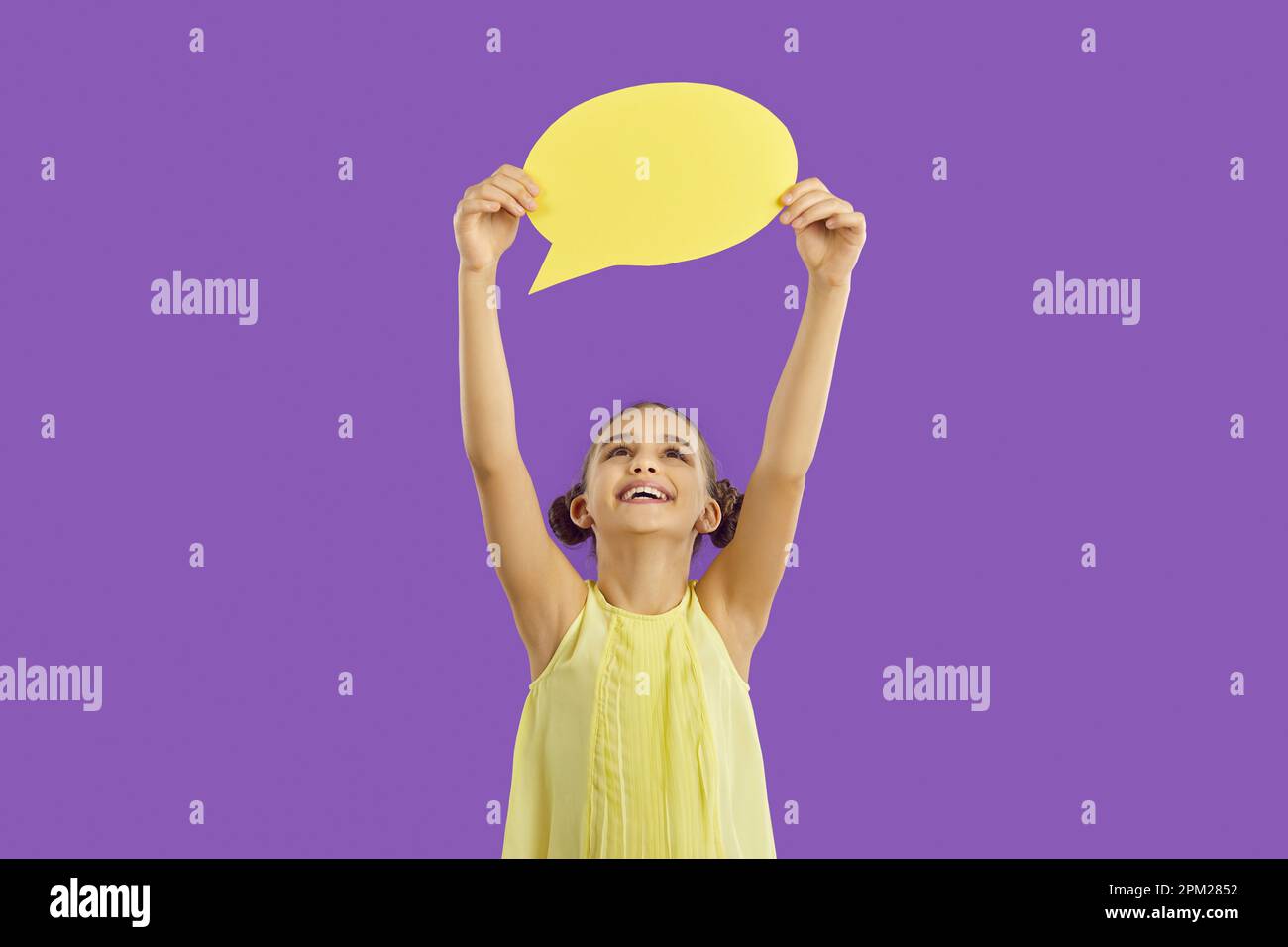 Happy schoolgirl who has correct answer to question raises up speech ...