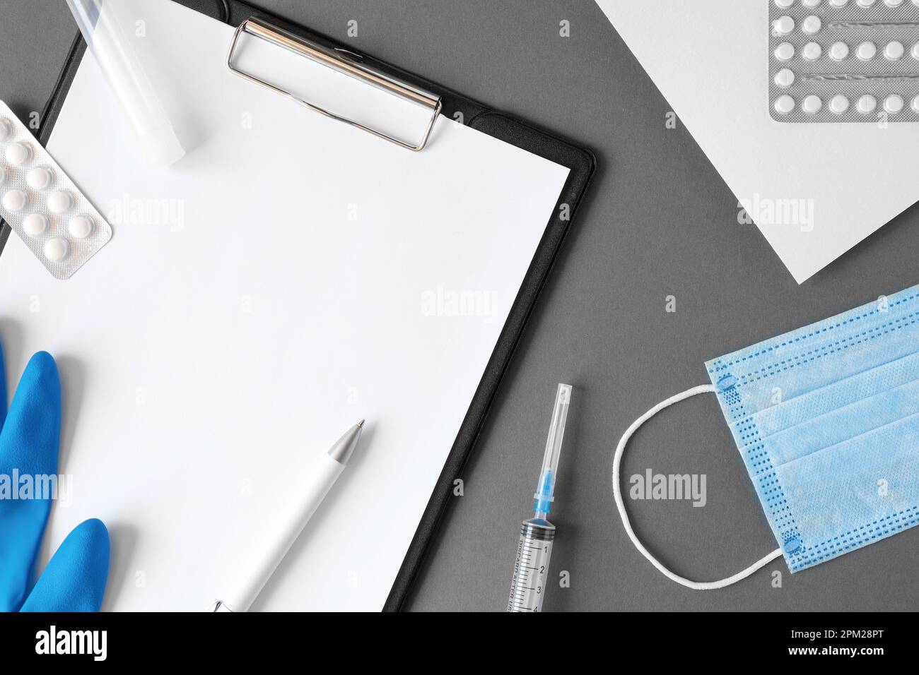 Gray modern doctor desk table with mask, notepad, syringe, sanitizer ...