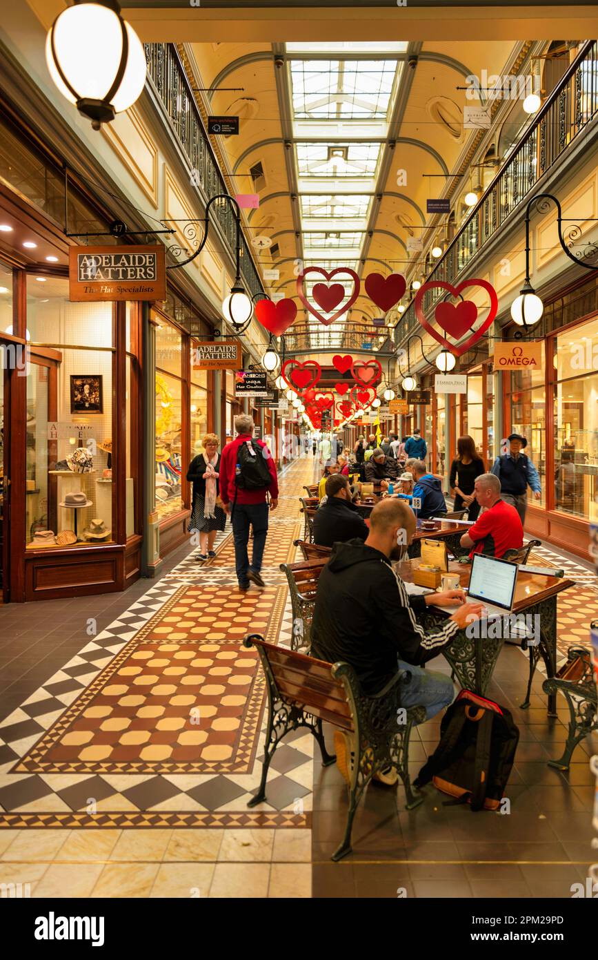 A bustling town square with people walking around the buildings in ...