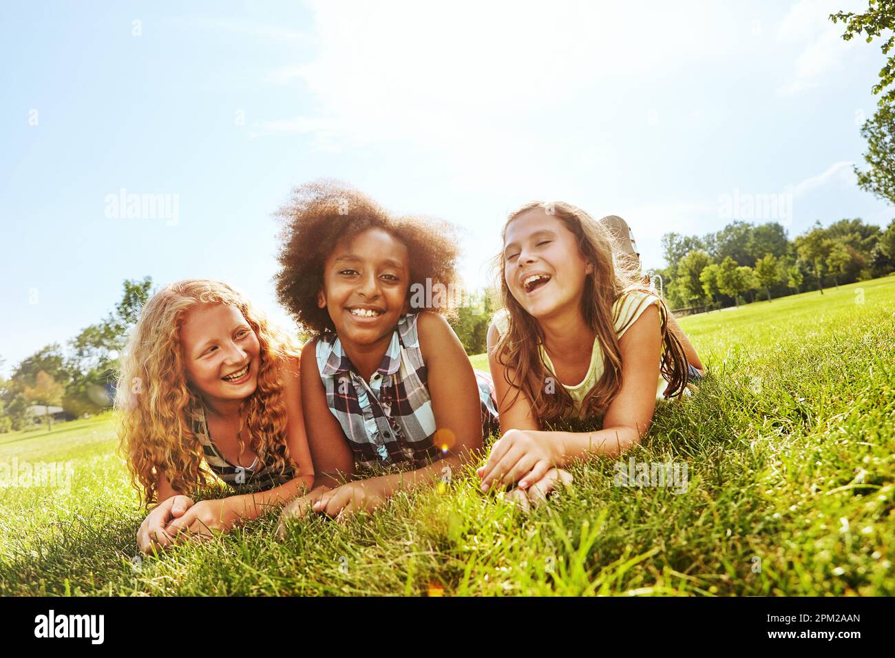Good times with my gals. three young girls lying together on the grass ...