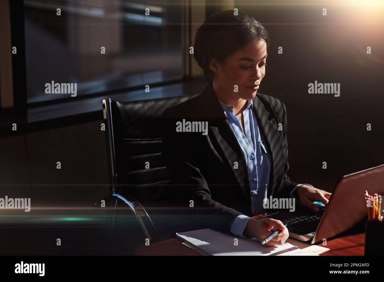 Checking out documents online. a businesswoman using her laptop at her desk Stock Photo - Alamy