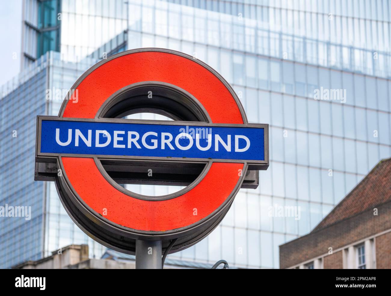 Low angle view of the iconic London Underground roundel sign, against a ...