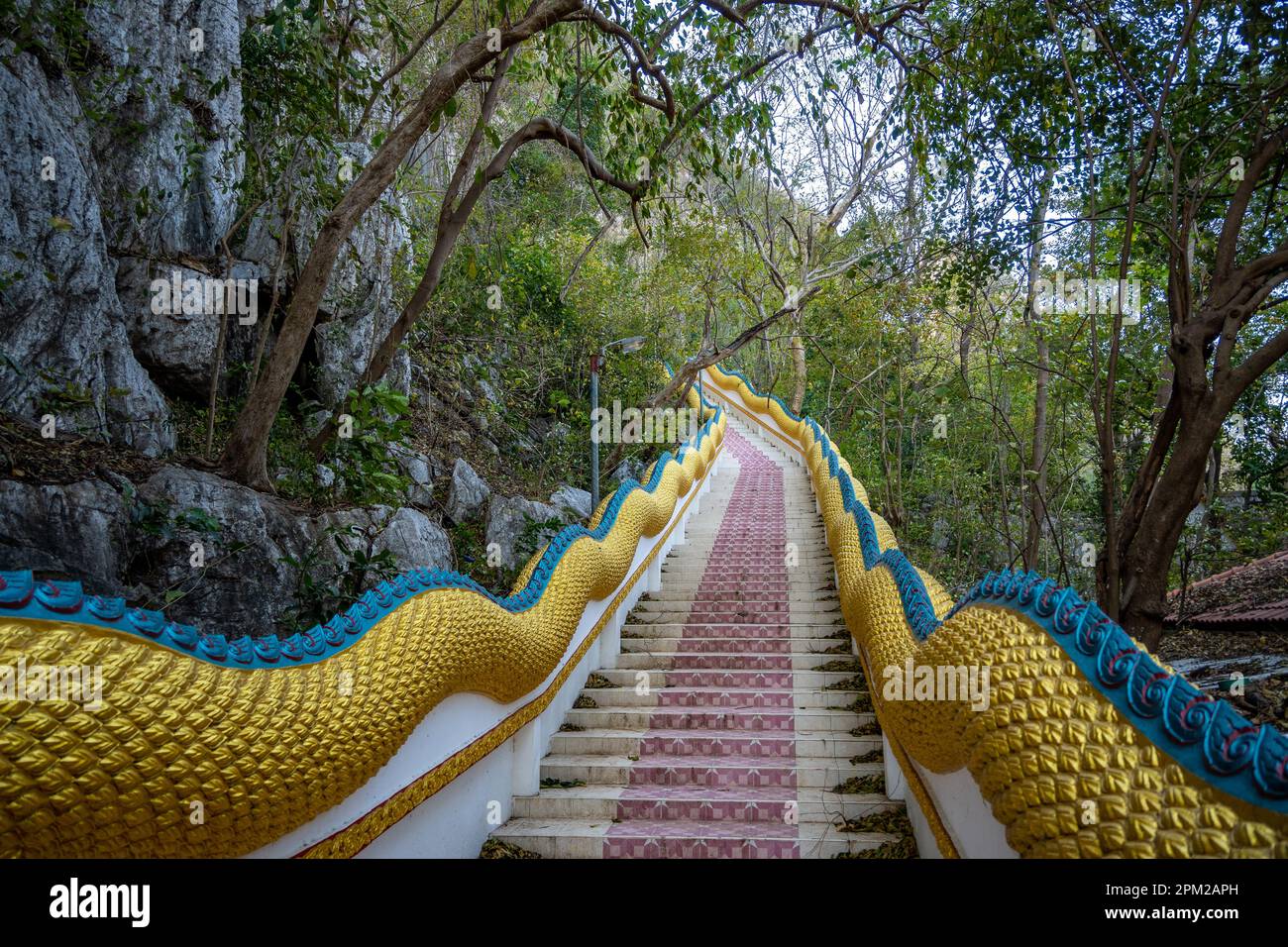 Steps up to a limestone hill decorated with dragons at Wat Phra ...