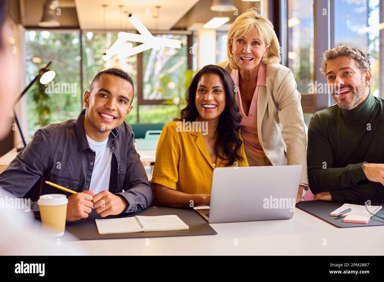 Business team collaborating around desk hi-res stock photography and ...