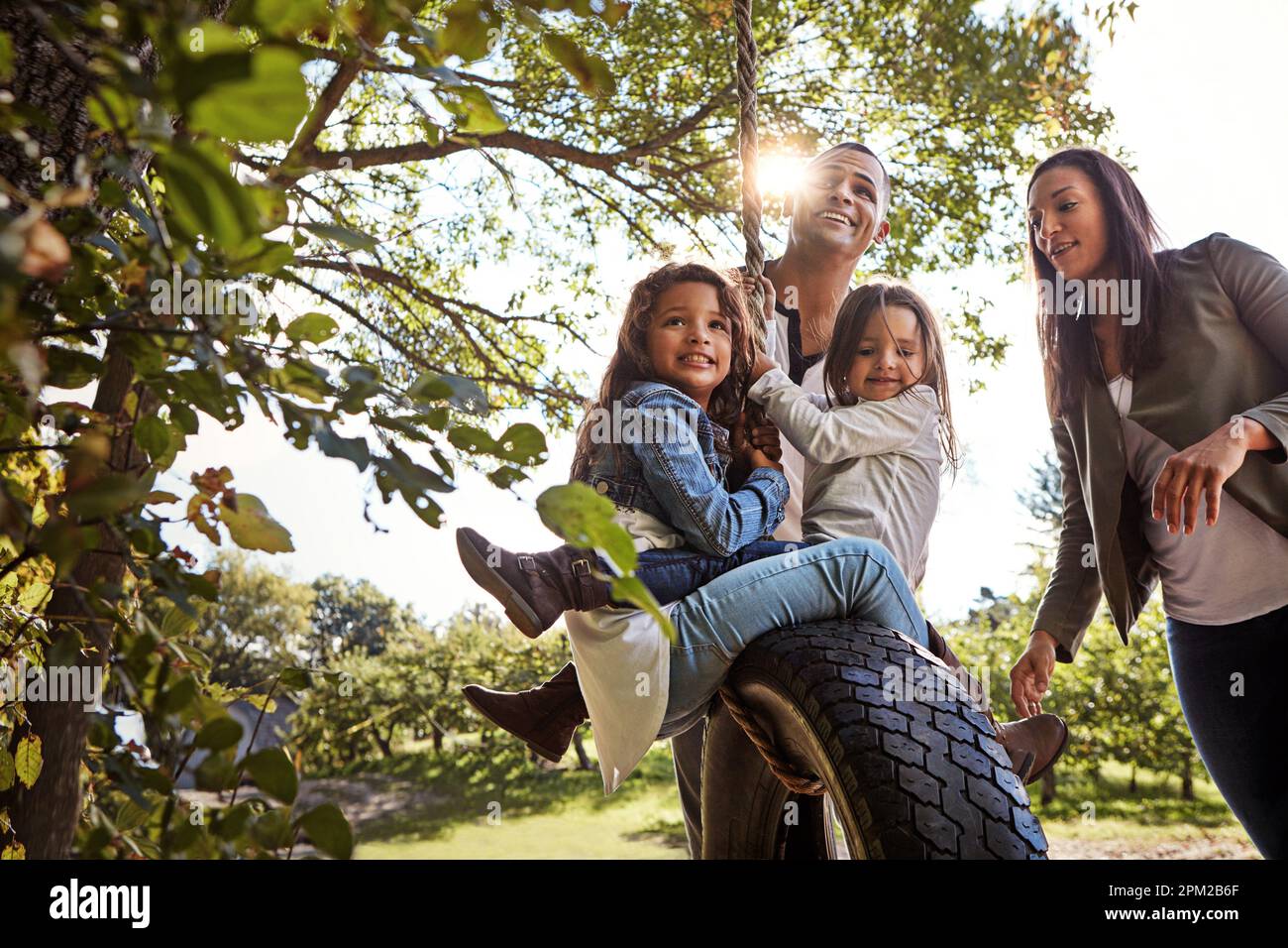 Playtime is a family affair. a happy mother and father pushing their ...