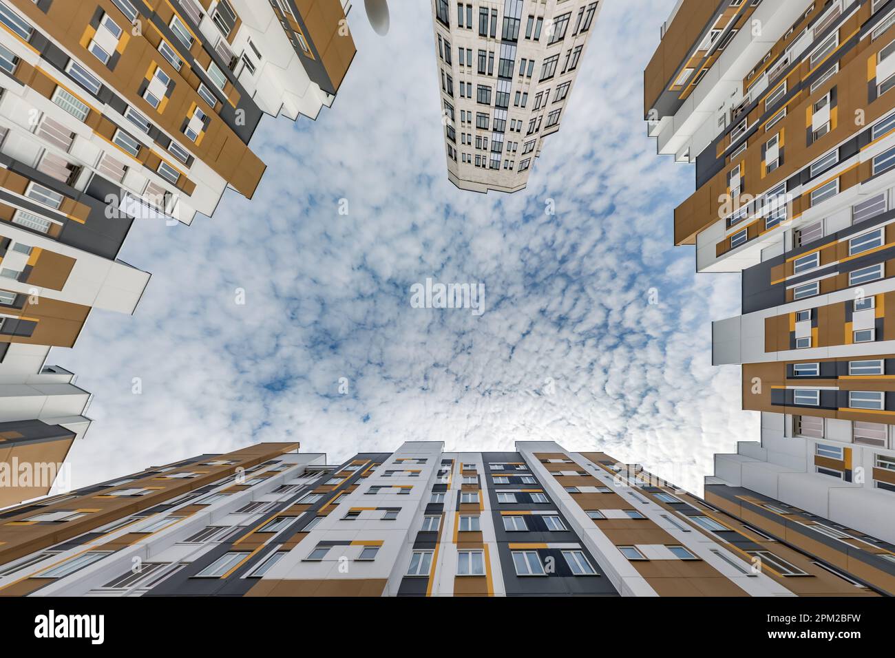 view up from ground to blue sky among skyscrapers, look at house from ...