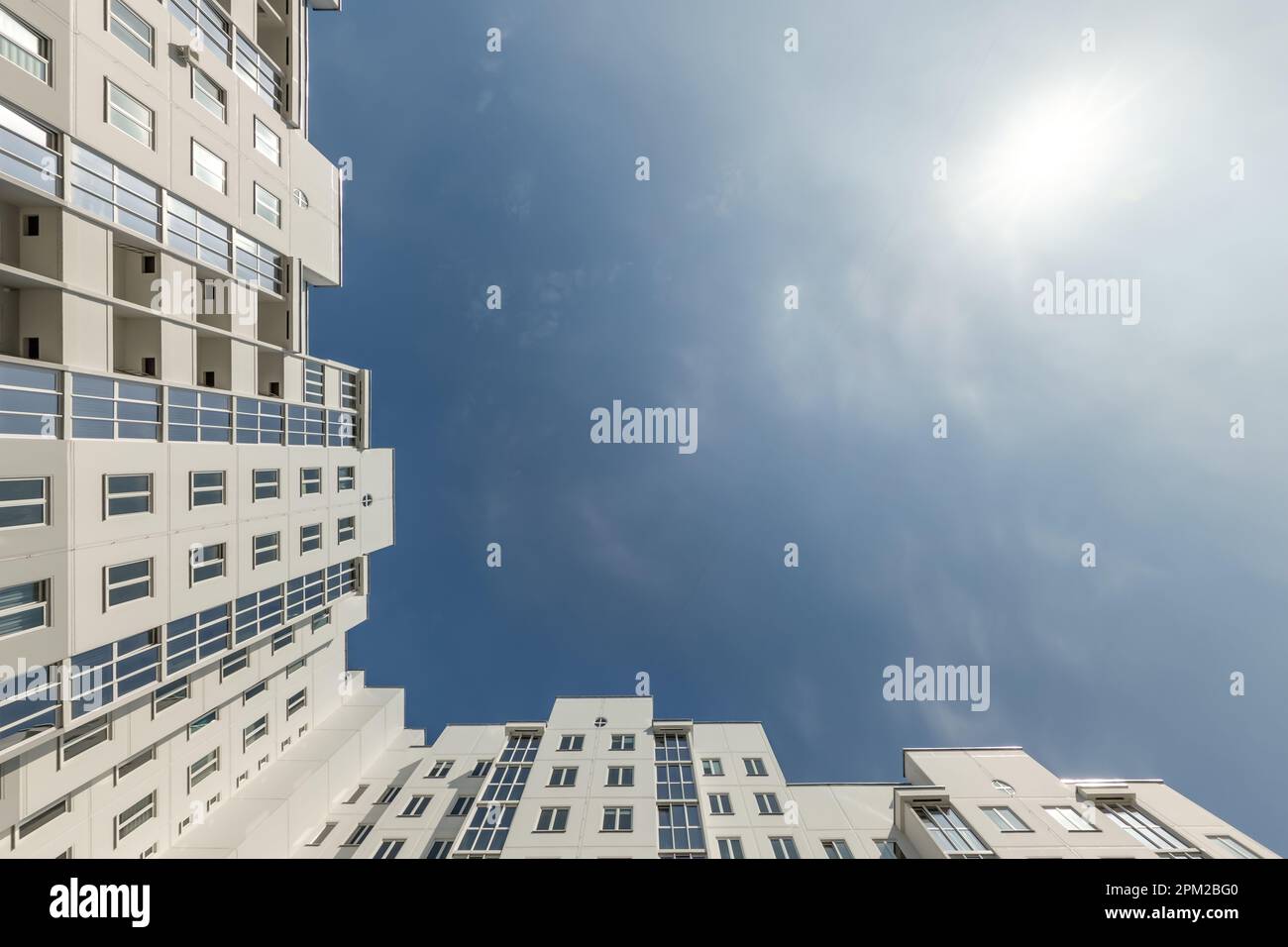 view up from ground to blue sky among skyscrapers, look at house from ...