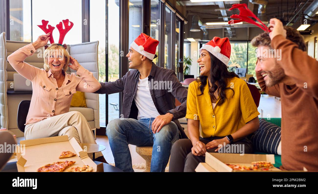 Staff Celebrating With Christmas Party And Meal In Office Stock Photo ...
