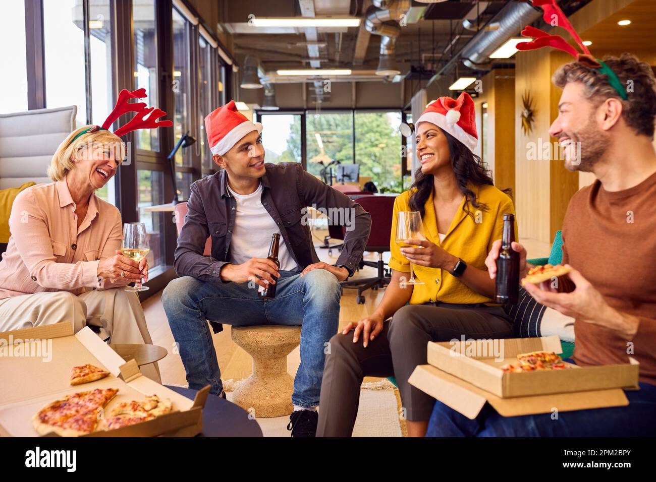 Staff Celebrating At Christmas Party With Meal And Drinks In Office ...