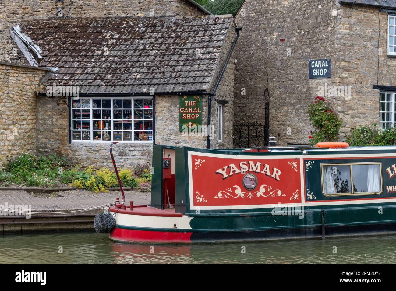 Colourful narrowboat in summer on the Grand Union canal, Stoke Bruerne ...