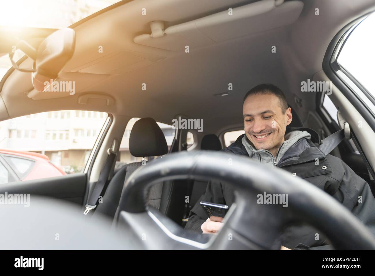 Joyful indian man driving car, shot from dashboard, going on trip ...