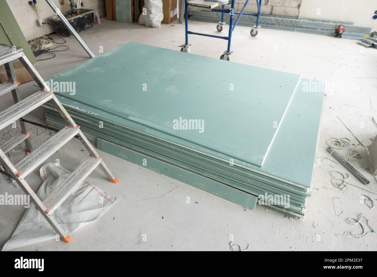 Construction worker, making walls from gypsum plasterboard or drywall ...