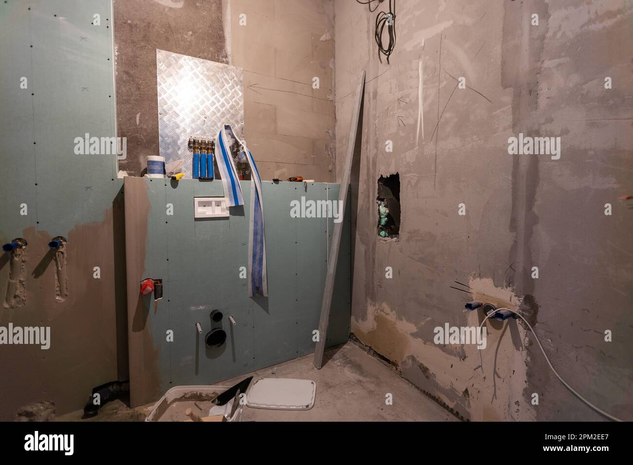 Workers are installing plasterboard (drywall) for gypsum walls in ...